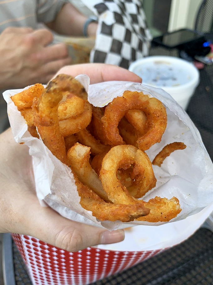 These curly fries aren't just side dishes; they're spiralized potato masterpieces that dance their way from the paper basket to your taste buds.