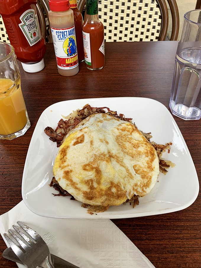 Two golden-yolked eggs atop a mountain of corned beef hash—like a sunrise over the most delicious landscape imaginable.