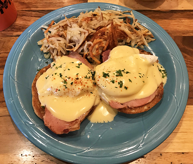 Eggs Benedict executed with textbook perfection&mdash;hollandaise sauce flowing like a golden waterfall over perfectly poached eggs and Canadian bacon.