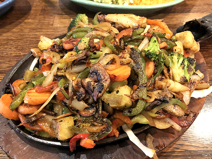 A sizzling skillet of veggie fajitas with char marks that tell stories of proper heat. The kind of dish that makes neighboring tables suffer from order envy.