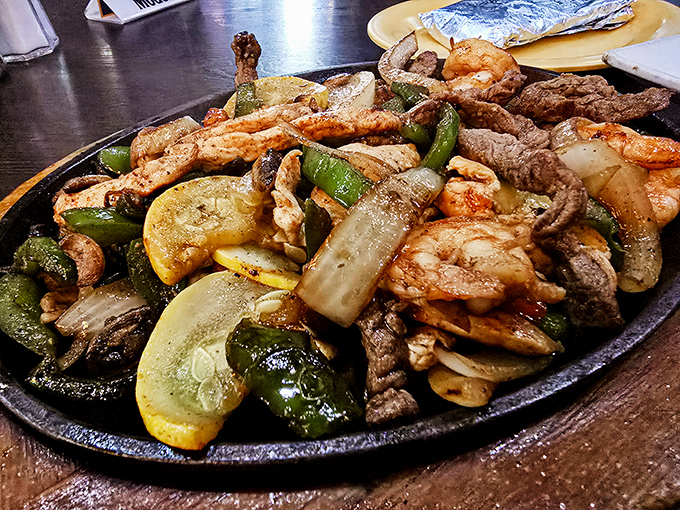 Sizzling fajitas with enough protein variety to satisfy an entire CrossFit class. The steam rising carries aromas that make neighboring tables jealous.