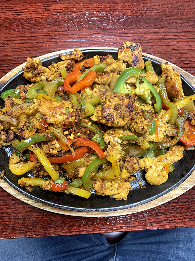 Sizzling chicken fajitas that announce their arrival before you see them. The peppers and onions are practically dancing in that hot skillet.