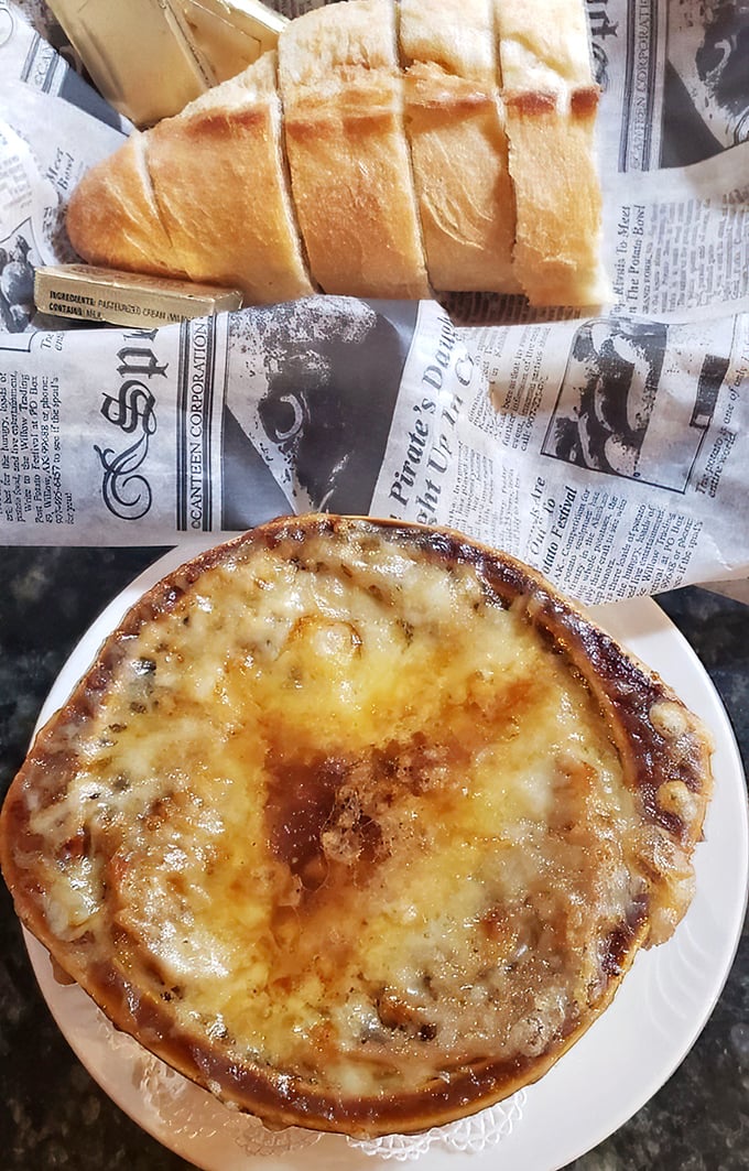 The newspaper might have today's headlines, but this French onion soup is making tomorrow's food section. That bread slice is living its best life.