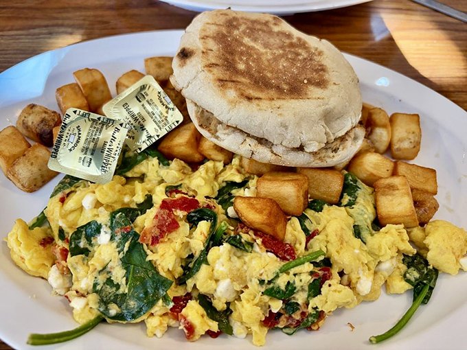 Breakfast reimagined: Mediterranean meets diner classic in this vibrant scramble that proves eggs can be both a comfort food and an adventure.