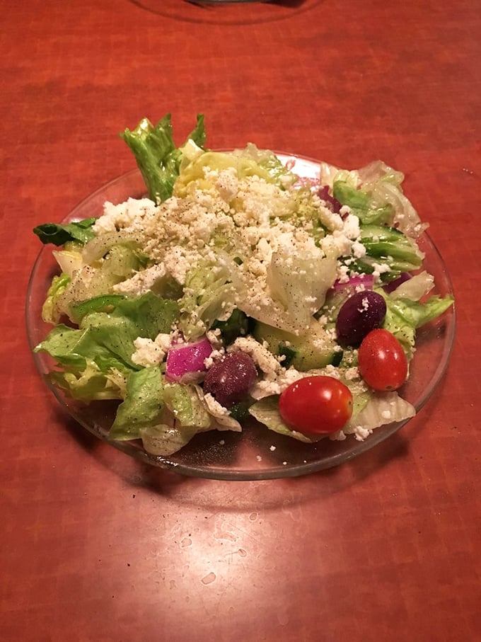 The Greek salad that launched a thousand forks. Briny olives, crumbled feta, and garden-fresh vegetables dressed in herbs that transport you straight to Santorini.