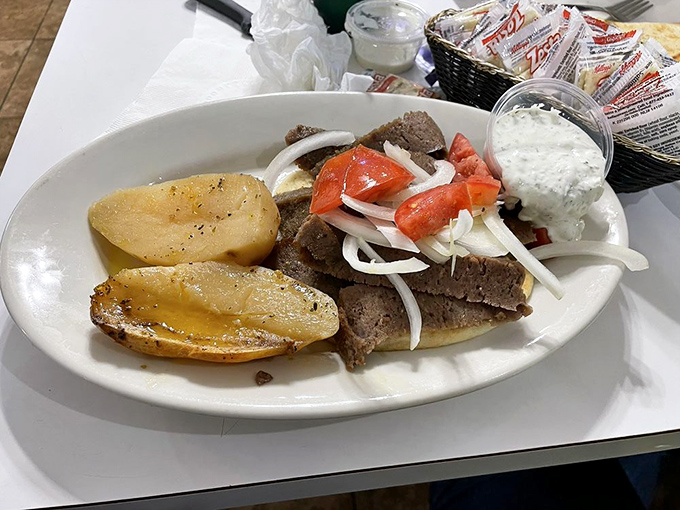 The gyro in its natural habitat—surrounded by golden potatoes and awaiting its tzatziki companion. A meal that proves Nebraska and Greece aren't as far apart as geography suggests.
