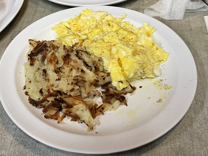 Sunny-side up eggs with a side of crispy-edged hash browns. Breakfast's greatest love story, told in golden hues. 