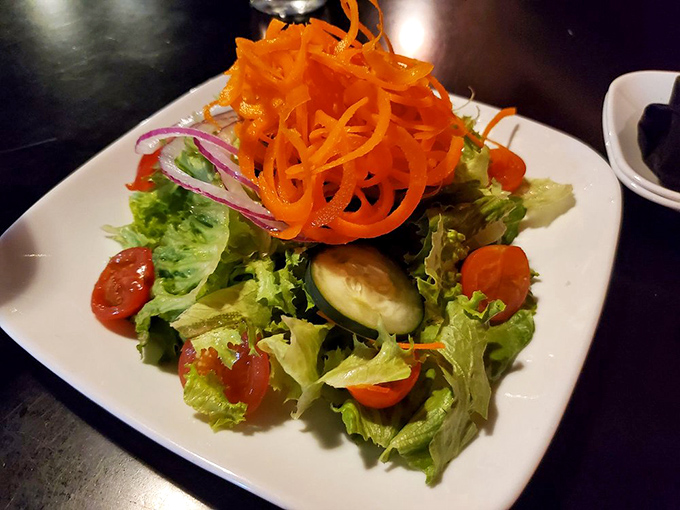 Even the salad has attitude at Kuma's. Those carrot curls are having more fun than most people on vacation.