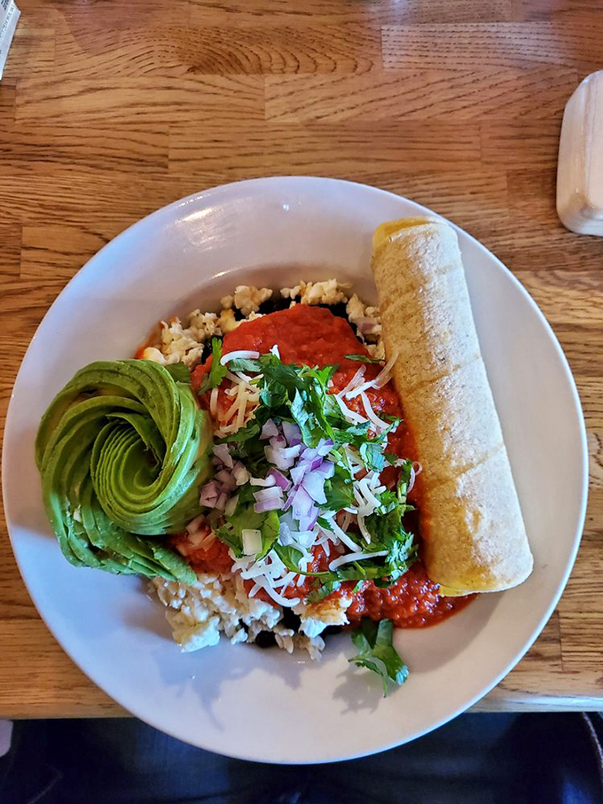 This isn't just breakfast &ndash; it's edible geometry. The perfect avocado rose beside vibrant salsa makes math suddenly delicious.