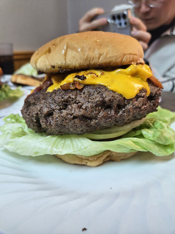 This isn't just a burger – it's a skyscraper of beef that requires architectural planning and possibly a building permit.