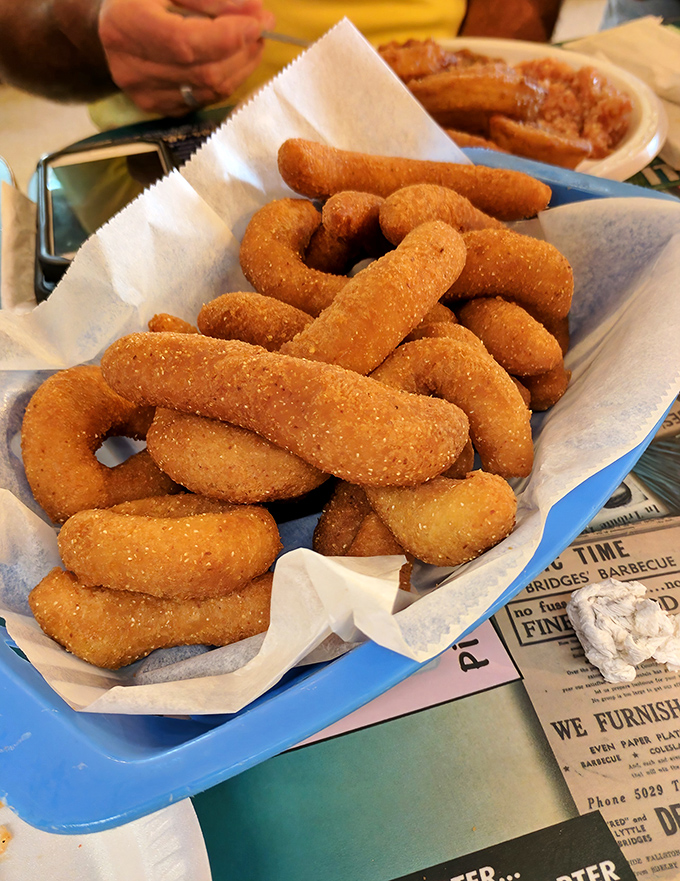 These golden hushpuppies aren't just side dishes&mdash;they're crispy little vessels designed specifically for sopping up barbecue sauce. Engineering at its tastiest.