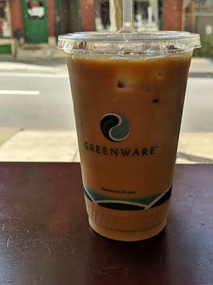 Iced coffee in a compostable cup &ndash; because saving the planet should never mean sacrificing your caffeine ritual.