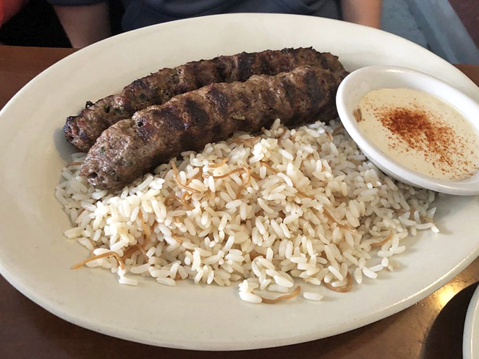 Kafta that could make a vegetarian weep with temptation. Perfectly grilled meat rests on a bed of rice, with hummus standing by for dipping duty.