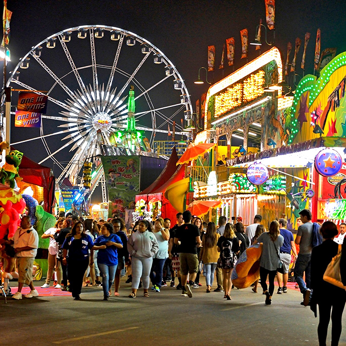 The county fair lights up the night with timeless carnival attractions – where the Ferris wheel provides both thrills and remarkable value compared to theme park prices.