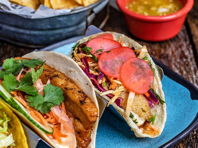 Fresh fish tacos adorned with vibrant pickled onions and herbs&mdash;like the ocean and garden decided to throw a party on a tortilla.