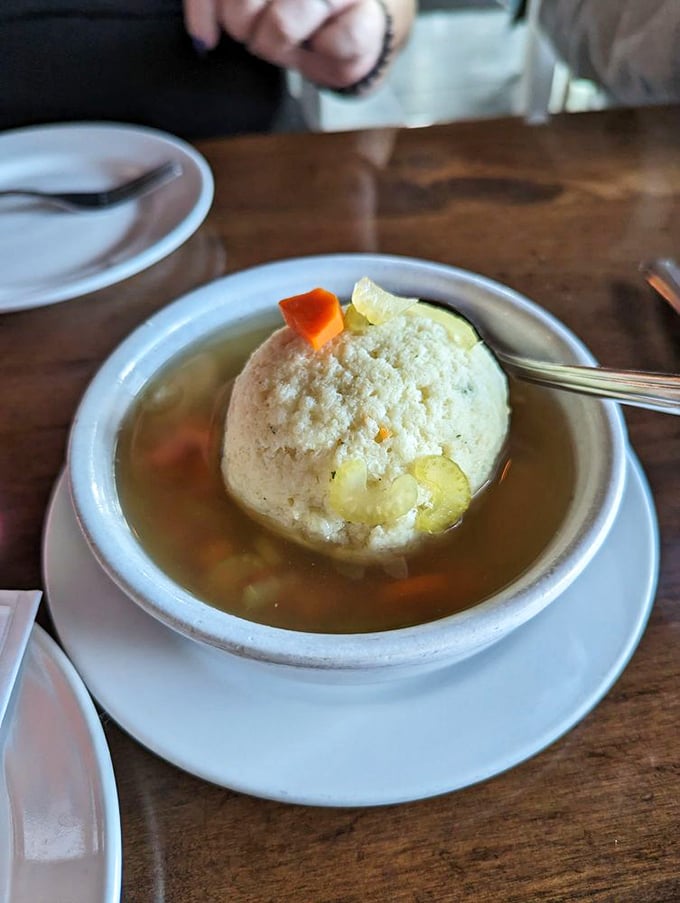 A matzo ball so perfectly centered it deserves its own architectural award. The carrots and celery are just supporting actors.