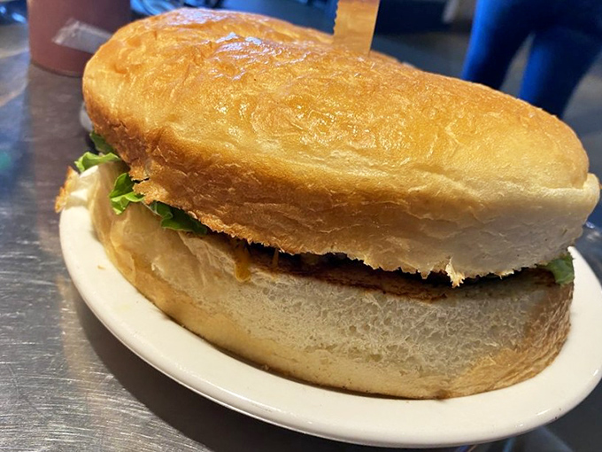 This isn't just a burger; it's a commitment. One pound of beef that requires both hands and possibly a signed waiver.