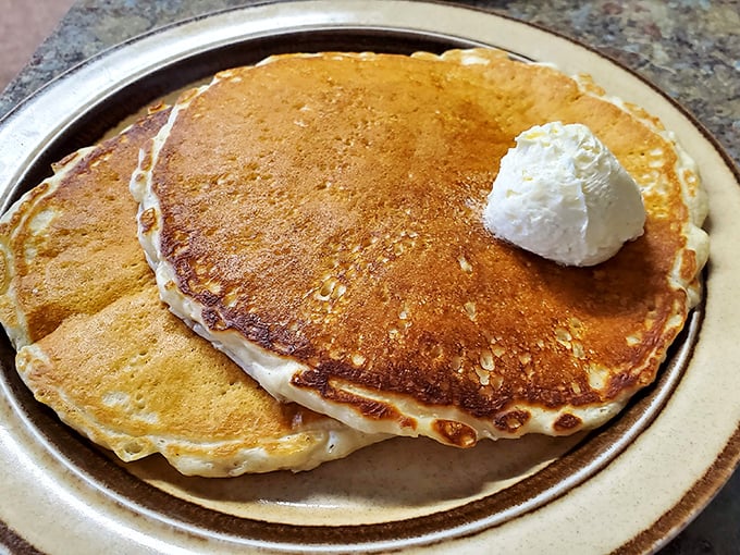 Pancakes that don't need fancy toppings to impress—just a dollop of butter melting into their fluffy, golden souls.