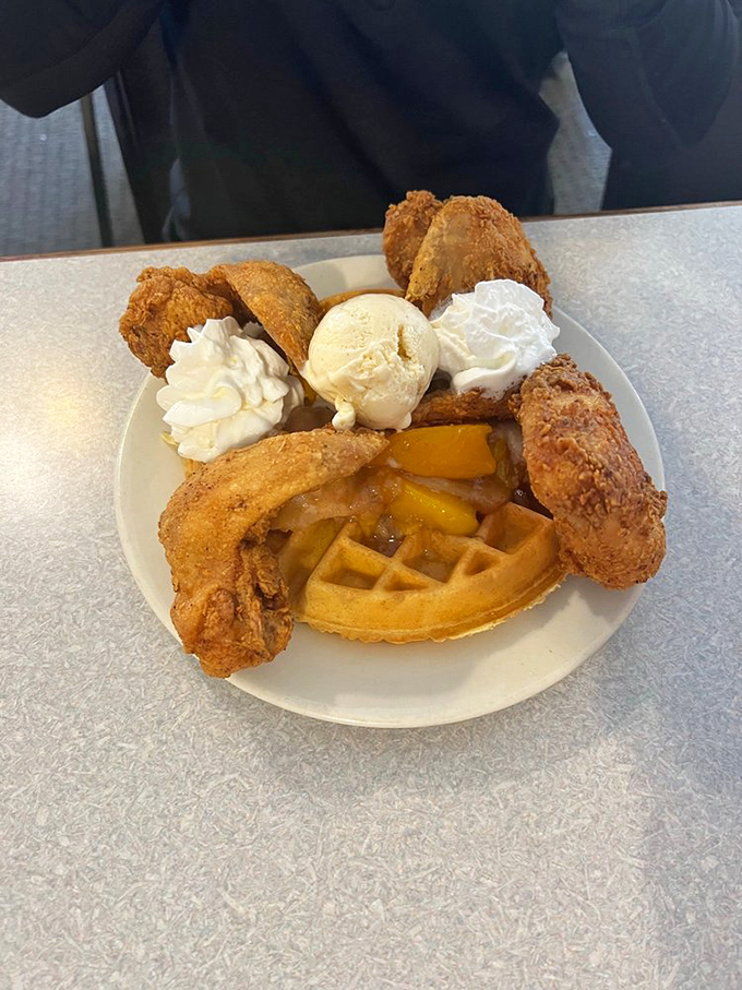 The Peach Cobbler Waffle comes with ice cream and fried chicken&mdash;dessert and dinner having a beautiful family reunion.