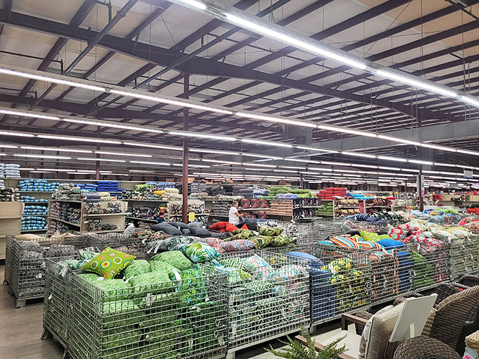 A textile treasure trove where pillows, beddings, and fabrics gather in metal bins like a soft, colorful farmer's market.