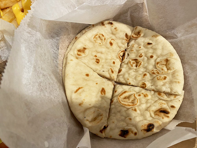 The unsung hero of any Greek meal&mdash;warm, fresh pita bread. Perfectly charred, pillowy soft, and ready for its supporting role in your lunch drama.