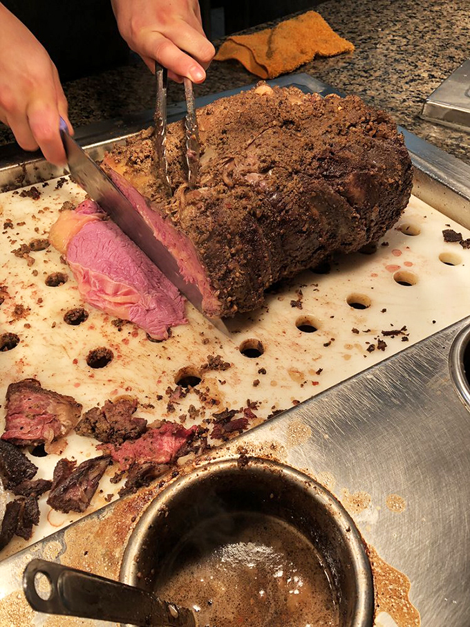 The prime rib carving station &ndash; where meat meets masterpiece. That perfect pink center isn't an accident; it's the result of kitchen expertise worth celebrating.
