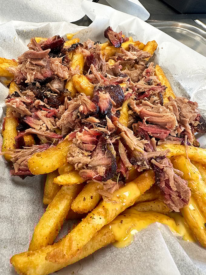 Pulled pork fries&mdash;because sometimes your comfort food needs its own comfort food. The cheese sauce is just nature's way of saying "you deserve this."