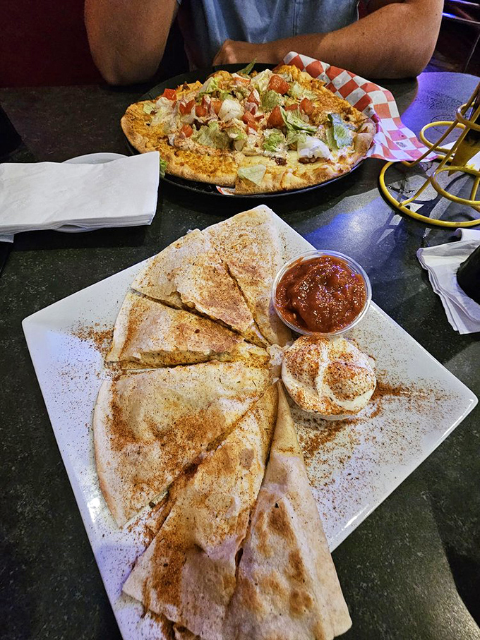 A taco pizza and quesadilla that would make any astronaut homesick for Earth. That sprinkle of spice across the plate? Stardust, obviously.