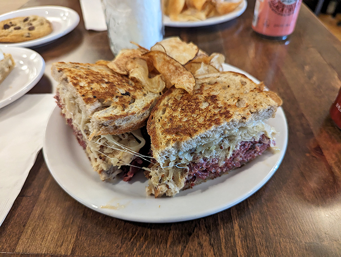 The Reuben: where corned beef, sauerkraut, and Swiss cheese achieve that rare perfect harmony. Like The Beatles, if The Beatles were a sandwich.