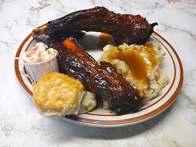 These ribs aren't just falling off the bone&mdash;they're practically jumping onto your fork, accompanied by mashed potatoes drowning happily in gravy.