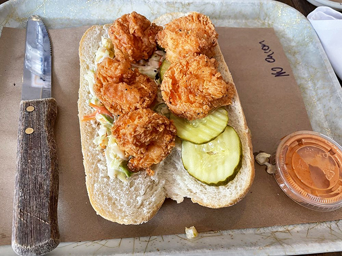 This sandwich isn't just food&mdash;it's architecture; crispy chicken stacked on pickles creating the skyscraper of satisfaction your lunch hour deserves.