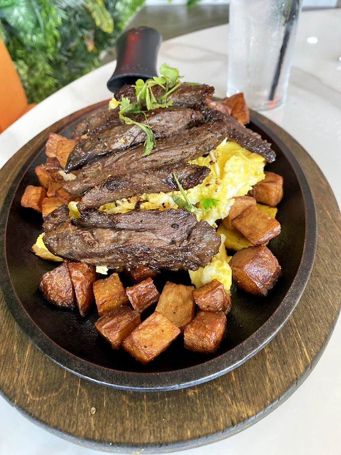 When steak and eggs arrive on a sizzling wooden platter, it's not just breakfast&mdash;it's a performance with delicious consequences.