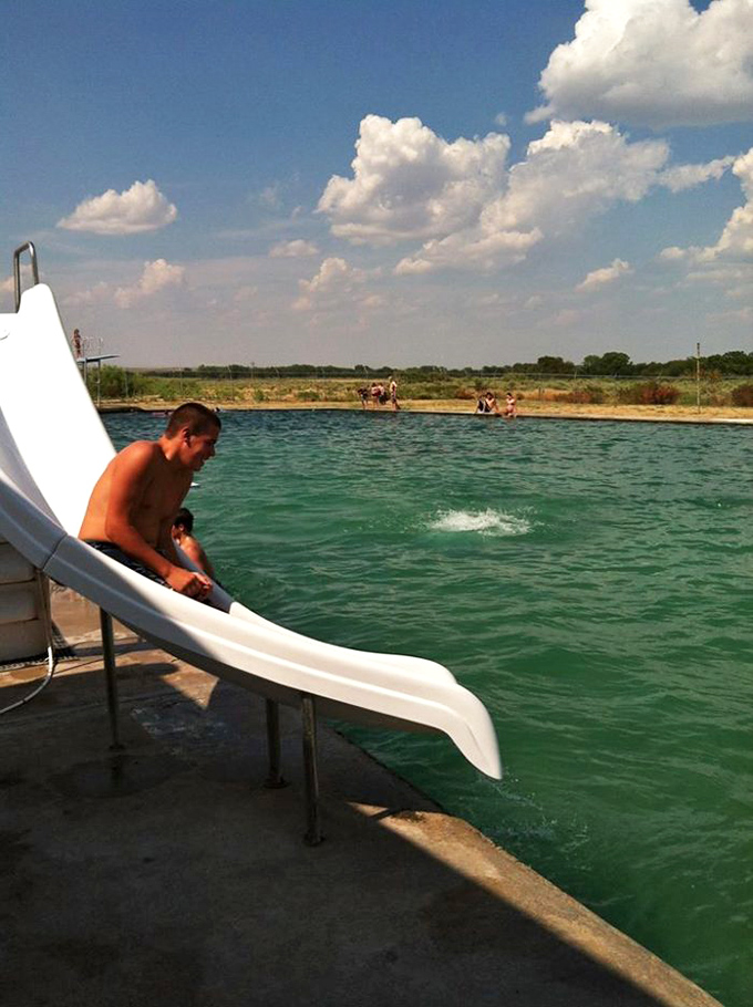 The slide delivers laughing visitors into refreshing mineral waters. Childhood joy doesn't need an ocean, just gravity and a splash landing.
