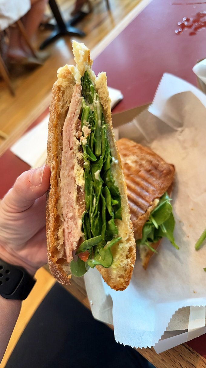A sandwich isn't just lunch&mdash;it's architecture. This turkey creation stacks fresh greens and protein between bread that deserves its own fan club.