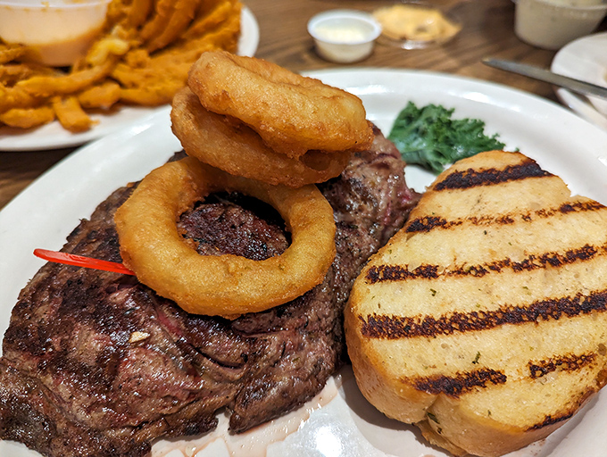 Surf meets turf in perfect harmony. Those onion rings perched atop the steak look like delicious golden halos.