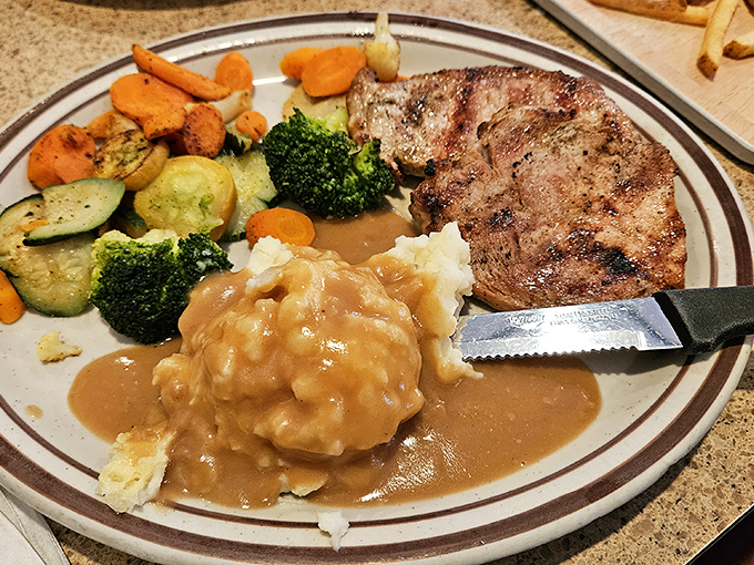 A perfectly cooked steak alongside vegetables and mashed potatoes drowning in gravy. Comfort food that hugs your soul from the inside out.