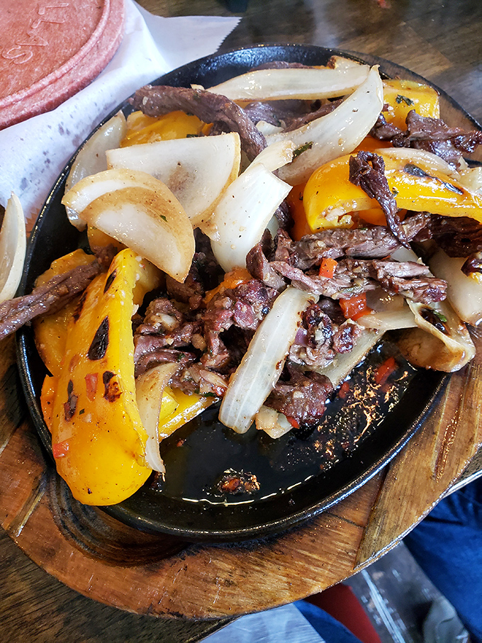 Sizzling steak fajitas that announce their arrival with both sound and aroma&mdash;the dinner theater we all deserve.