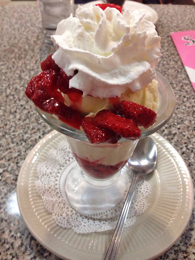 Strawberries and cream reimagined—nature's candy nestled against vanilla ice cream in a glass that belongs in the Dessert Hall of Fame.