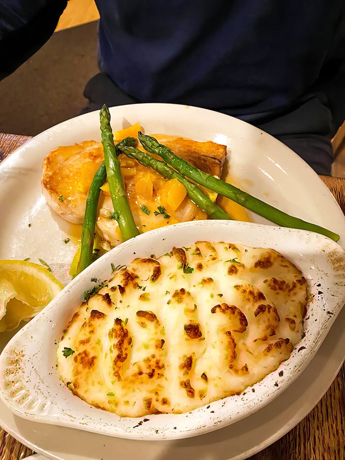 A seafood symphony on a plate—golden fish, perfectly broiled, alongside creamy potatoes au gratin. The asparagus adds color and the pretense of virtue.