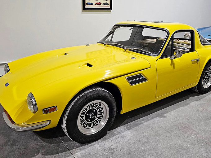 This sunshine-yellow TVR radiates pure automotive joy. With curves that would make a mountain road jealous, it's the sports car equivalent of a perfect summer day.