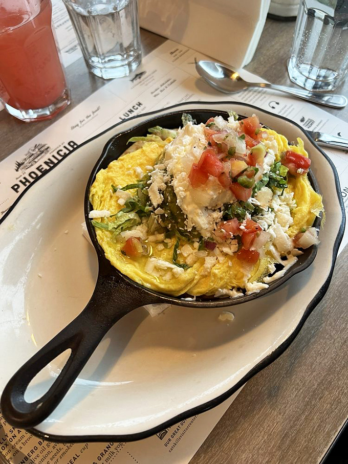 This isn't just an omelet—it's an edible love letter to fresh ingredients. The vibrant tomatoes and herbs create a breakfast symphony in cast iron.