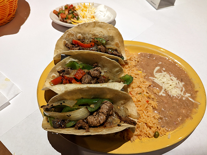 Three tacos walk into a bar... and become the highlight of someone's day. Simple street-style perfection with grilled peppers and onions.