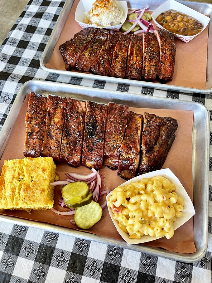 A tray of ribs and sides that makes you want to cancel your afternoon plans and surrender to the inevitable food coma.