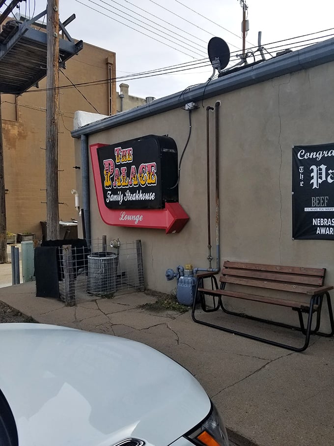 The Palace sign promises exactly what you want in a small-town steakhouse: no pretension, just the promise of a meal worth remembering.
