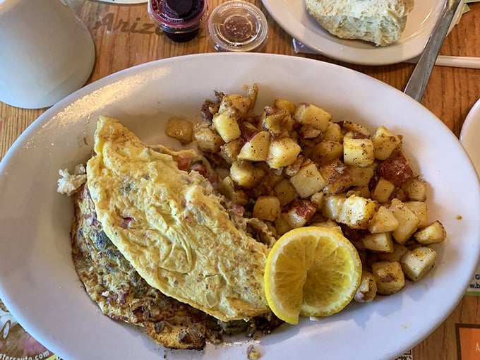 This omelet and potato combo isn't just breakfast, it's edible therapy with a side of citrus sunshine.