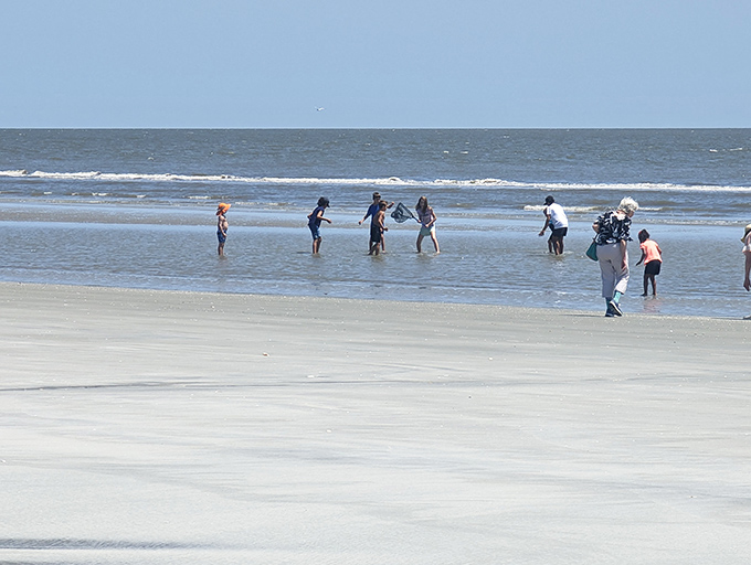 Shell seekers and wave chasers. On Nanny Goat Beach, the treasure hunt never ends as visitors comb the shoreline for nature's perfect souvenirs.