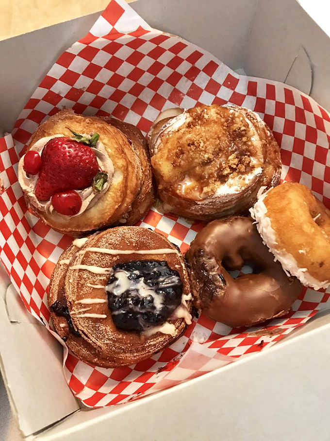 The pastry equivalent of a family portrait &ndash; cronuts and donuts nestled together in their red-checkered home. Adoption papers, please.