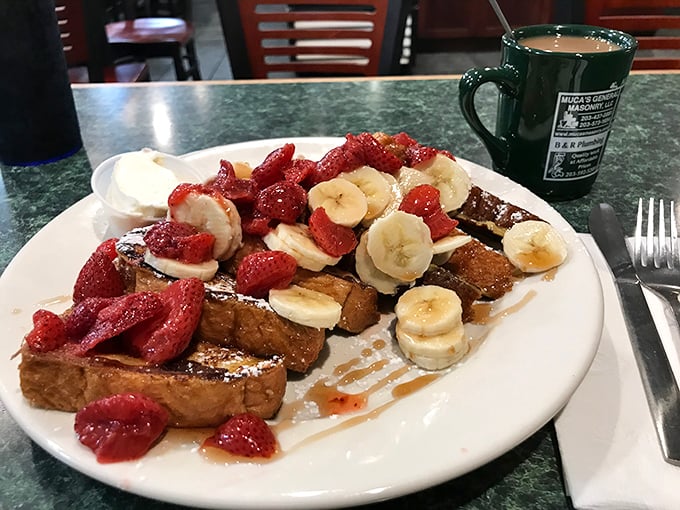 French toast that's having a party with fresh fruit. Bananas and strawberries dressed in their Sunday best for this breakfast celebration.