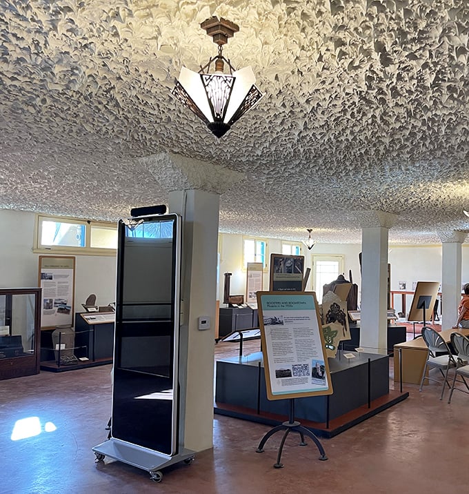 The textured ceiling looks like Arizona's famous meringue clouds frozen in time, while Art Deco lighting casts a warm glow over historical displays.