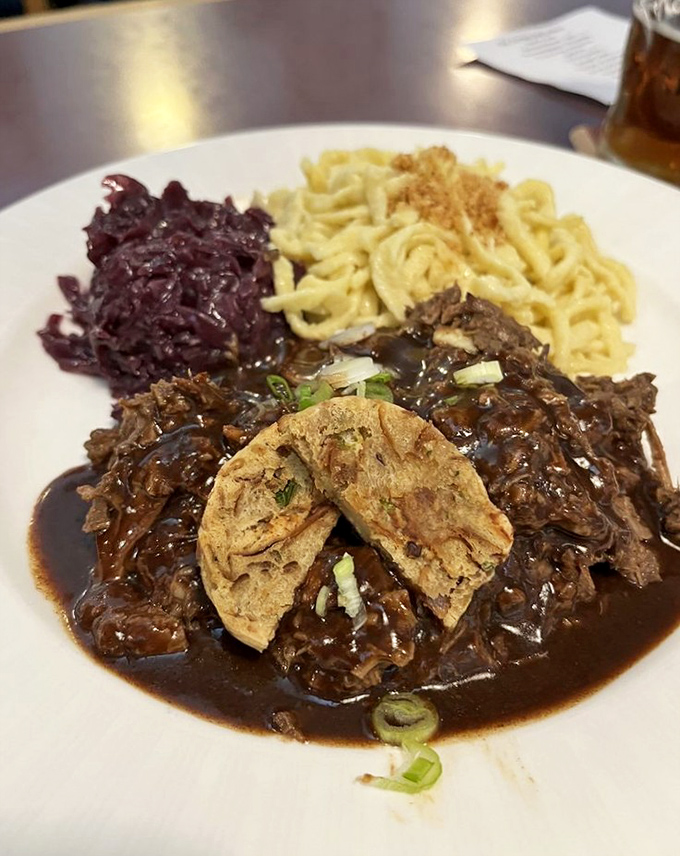 Sauerbraten with spätzle and red cabbage—a trio so harmonious they could release a German folk album together.